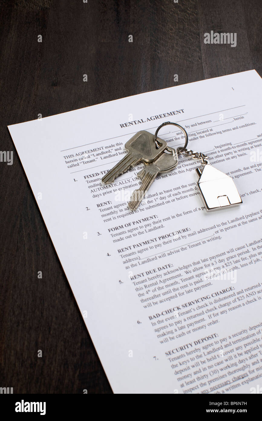A rental agreement and two keys on a house shaped key ring Stock Photo ...