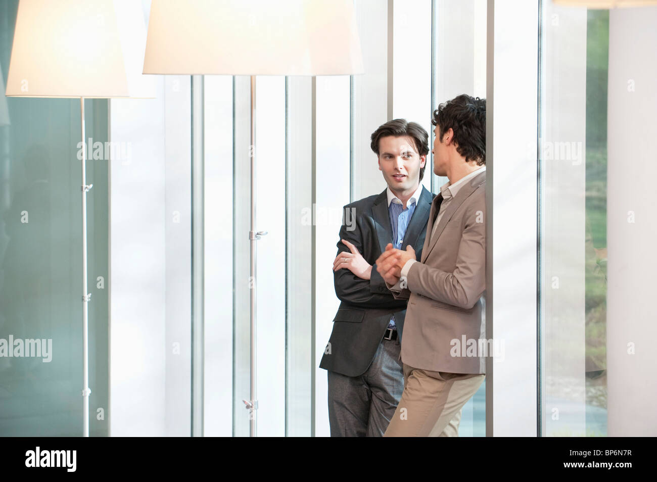 Two businessmen standing together Stock Photo - Alamy