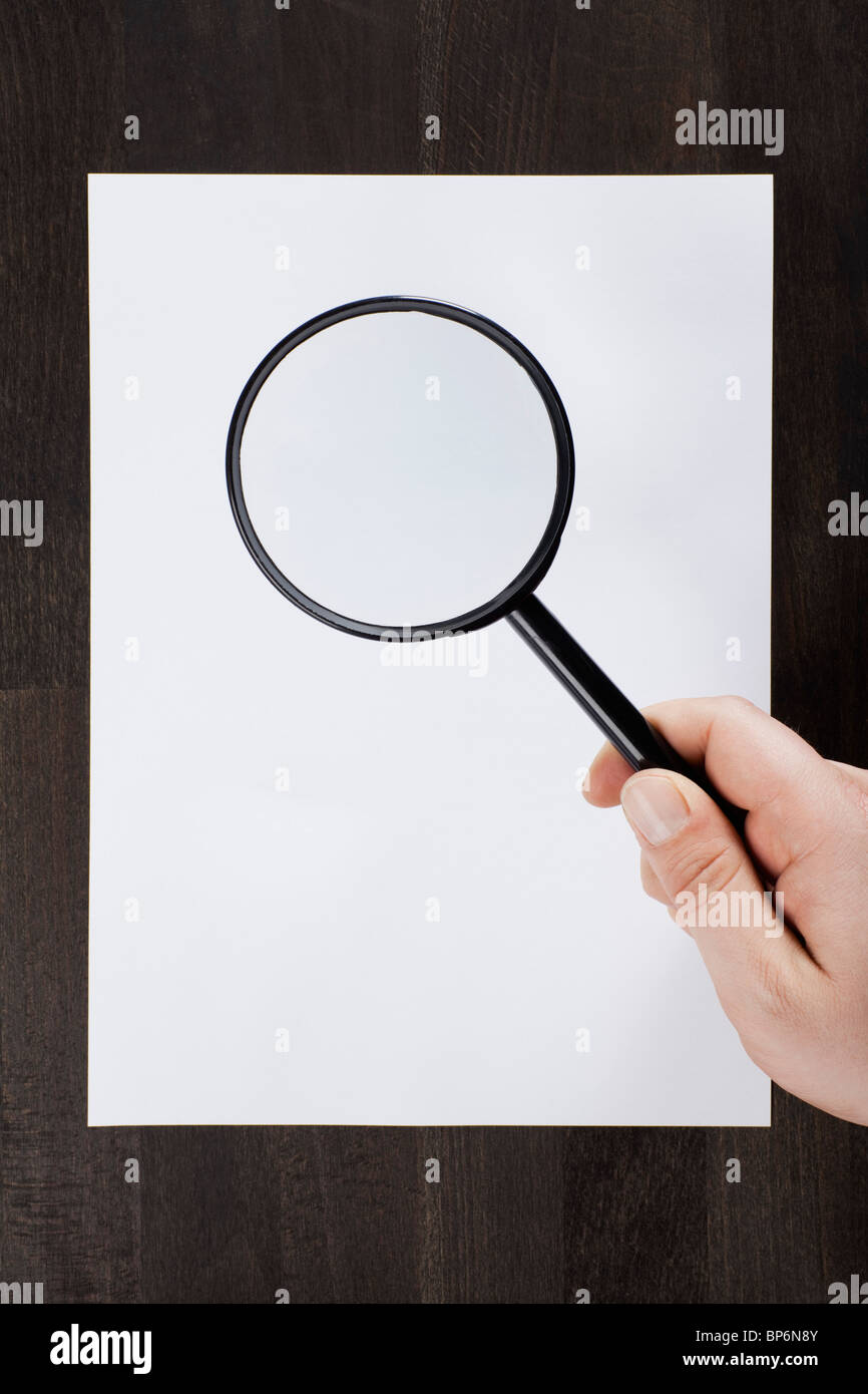 Examining a blank piece of paper Stock Photo - Alamy