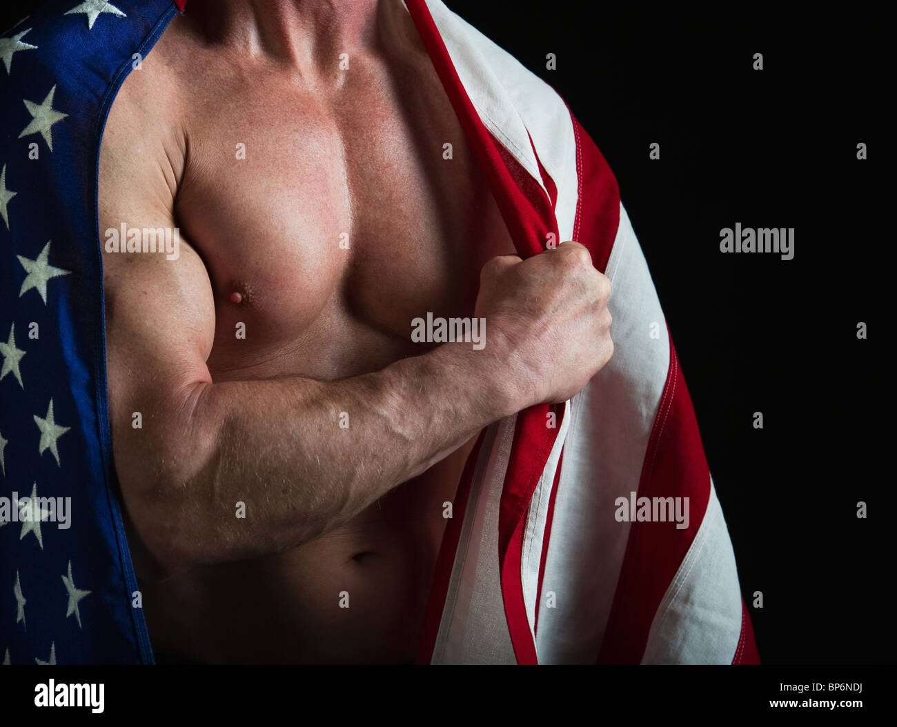 Muscular man wearing American flag as a cape Stock Photo - Alamy