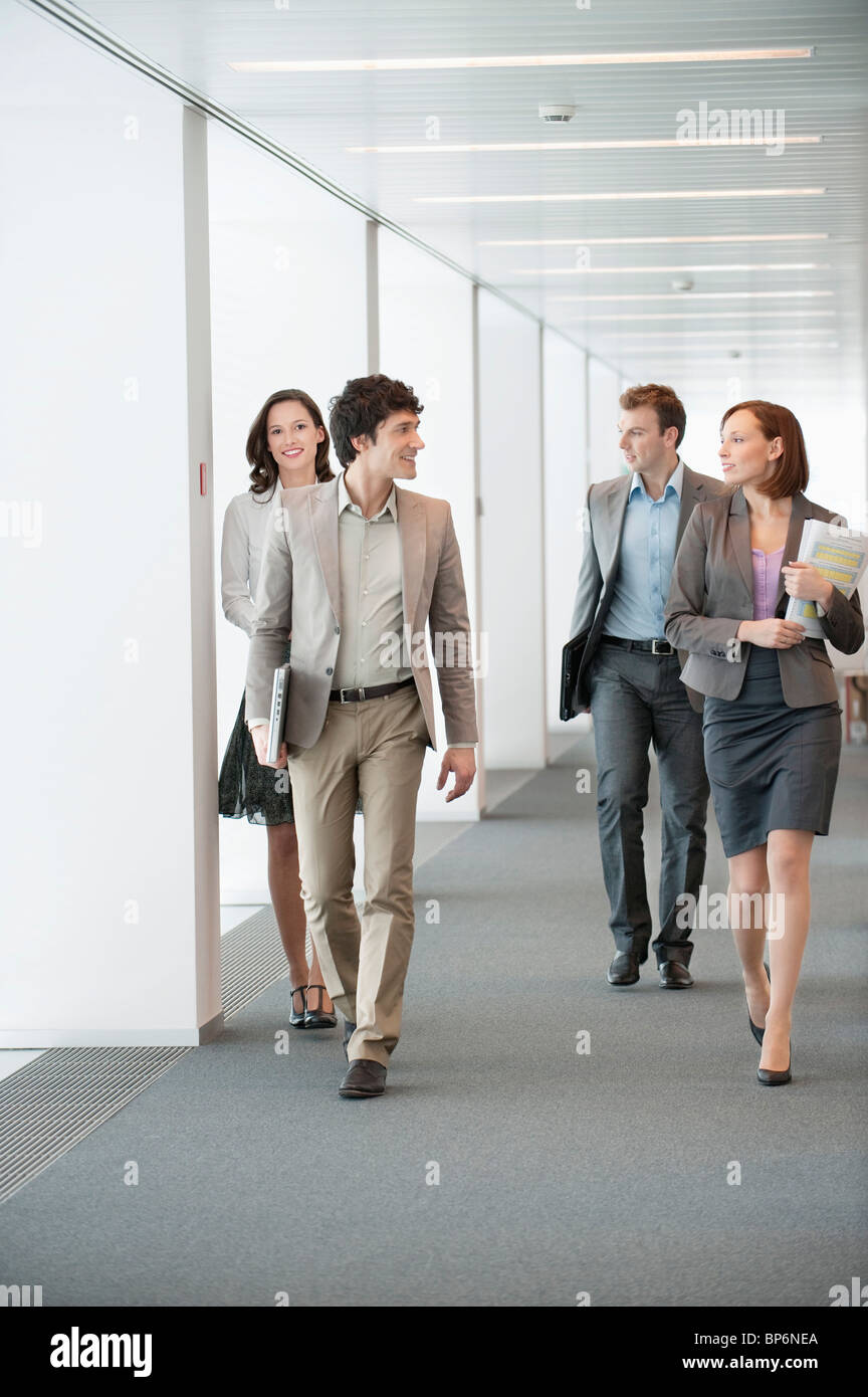 Business executives walking in the corridor of an office Stock Photo ...
