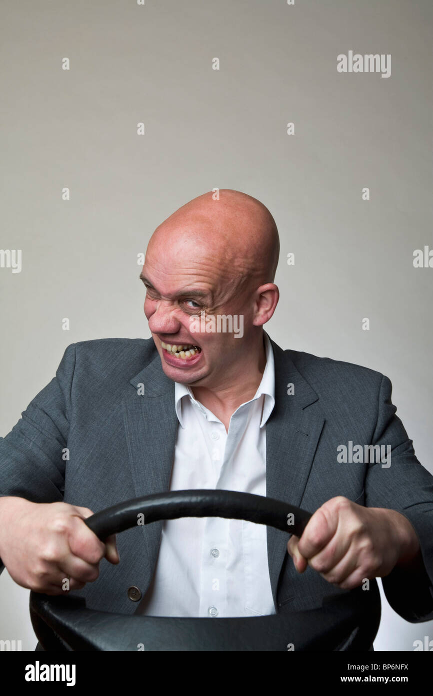 An angry man behind a car steering wheel Stock Photo - Alamy