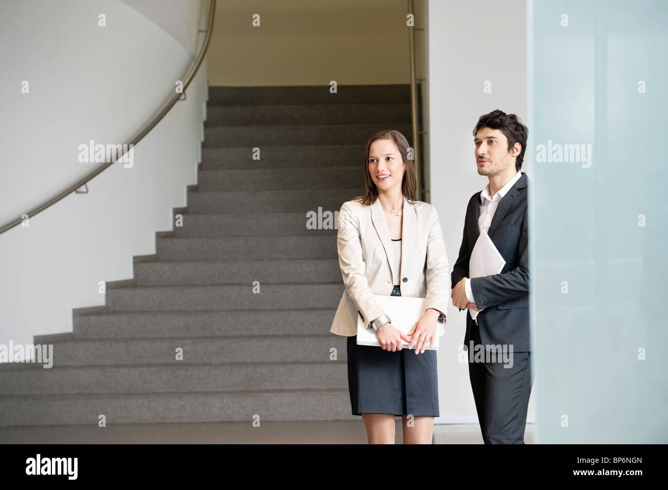 Two business executives standing in an office Stock Photo - Alamy