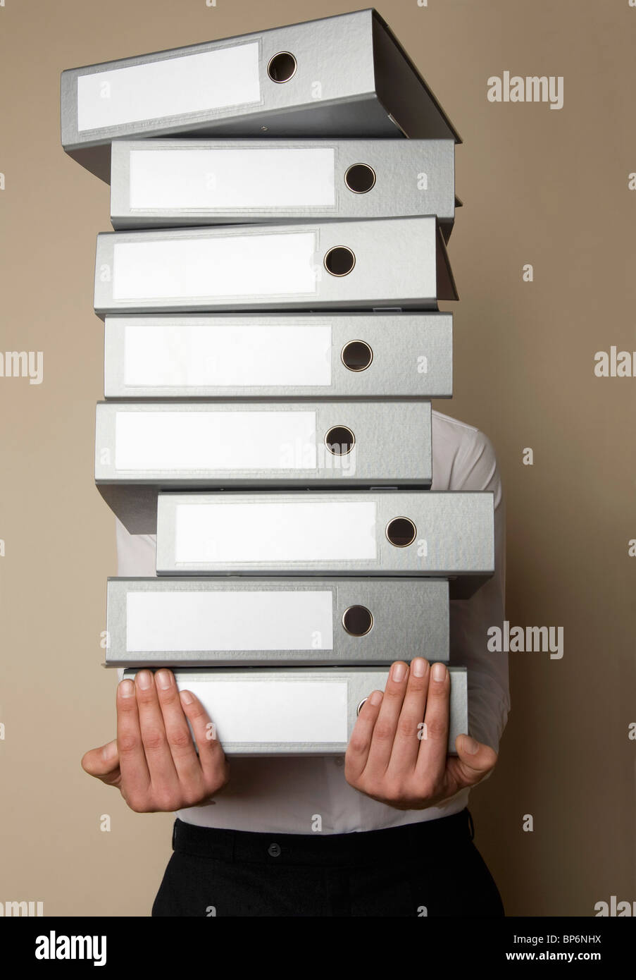 A man carrying a stack of folders Stock Photo - Alamy