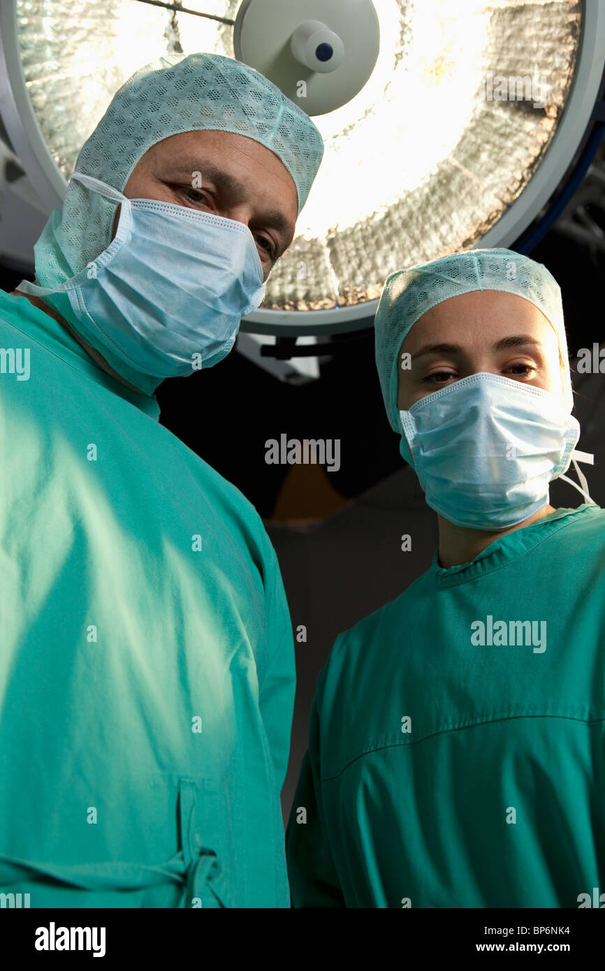 Two surgery staff standing in an operating room Stock Photo - Alamy