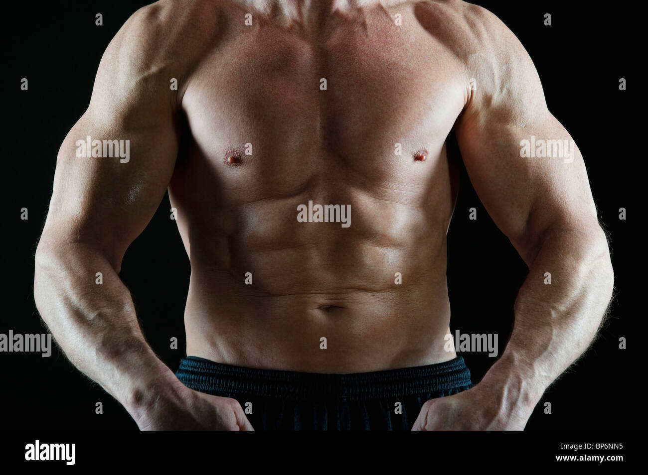 Muscular man flexing his muscles Stock Photo - Alamy