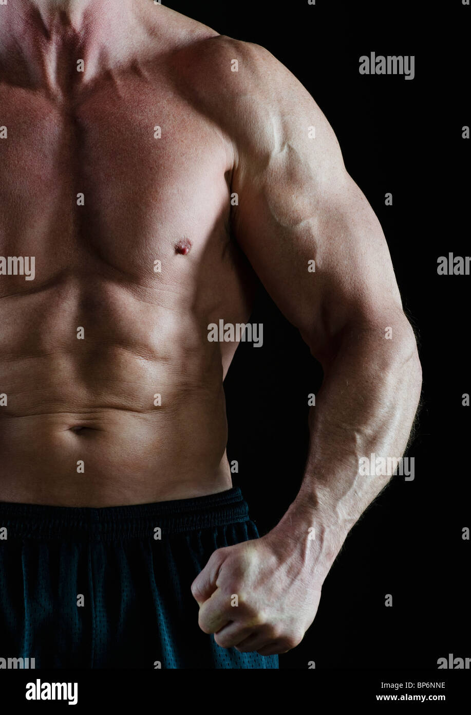 Muscular man flexing his muscles Stock Photo - Alamy