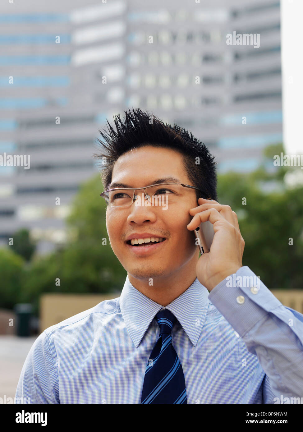 A smiling businessman using a mobile phone Stock Photo - Alamy