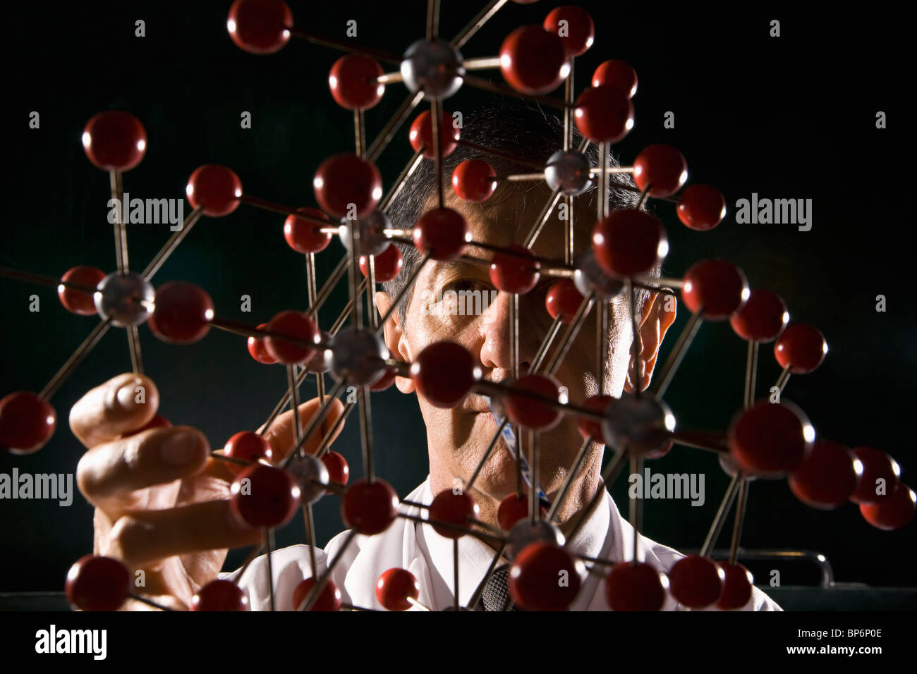 A scientist holding a molecular structure model Stock Photo - Alamy