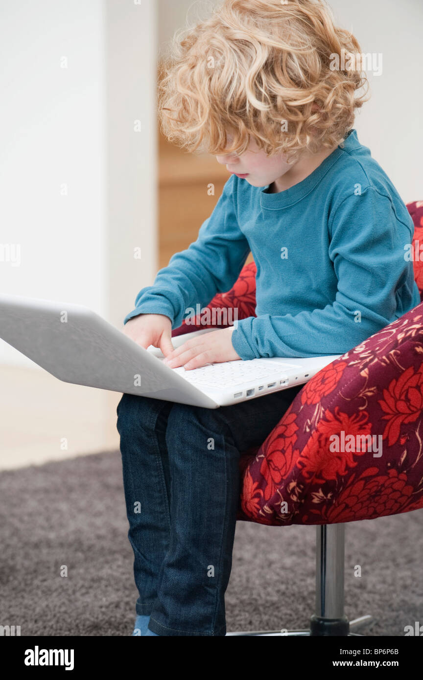 Boy using a laptop Stock Photo - Alamy
