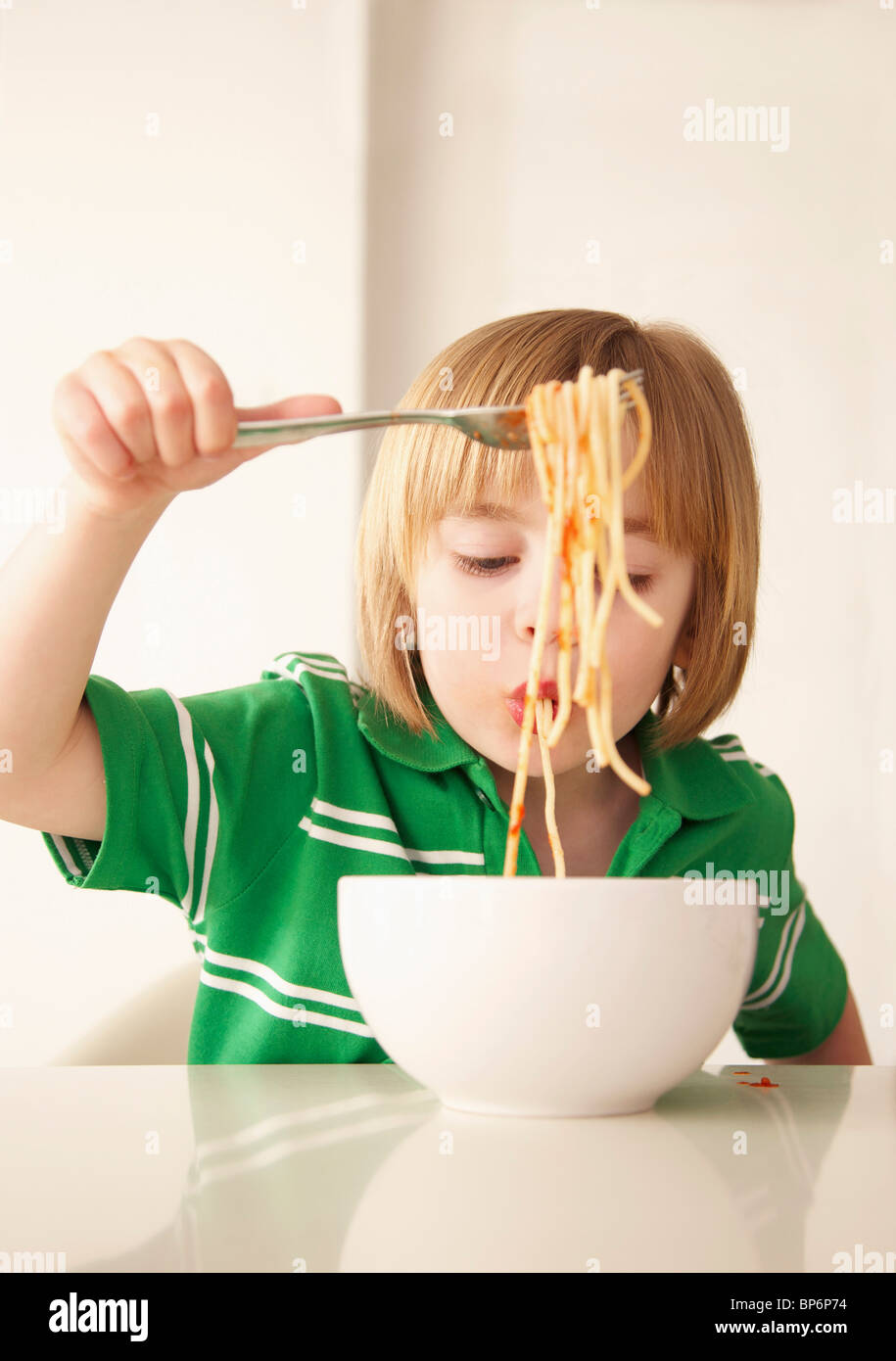 A boy eating spaghetti Stock Photo - Alamy