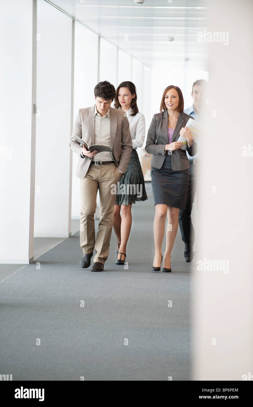 Business executives walking in the corridor of an office Stock Photo ...