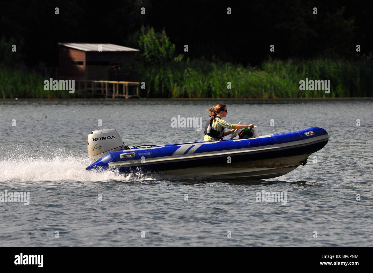 Woman driving boat hi-res stock photography and images - Alamy