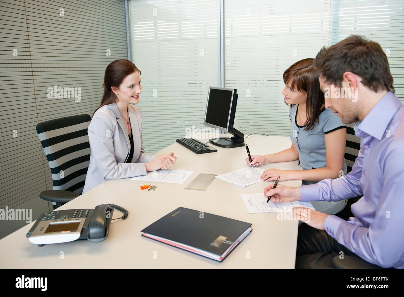Couple signing form hi-res stock photography and images - Alamy