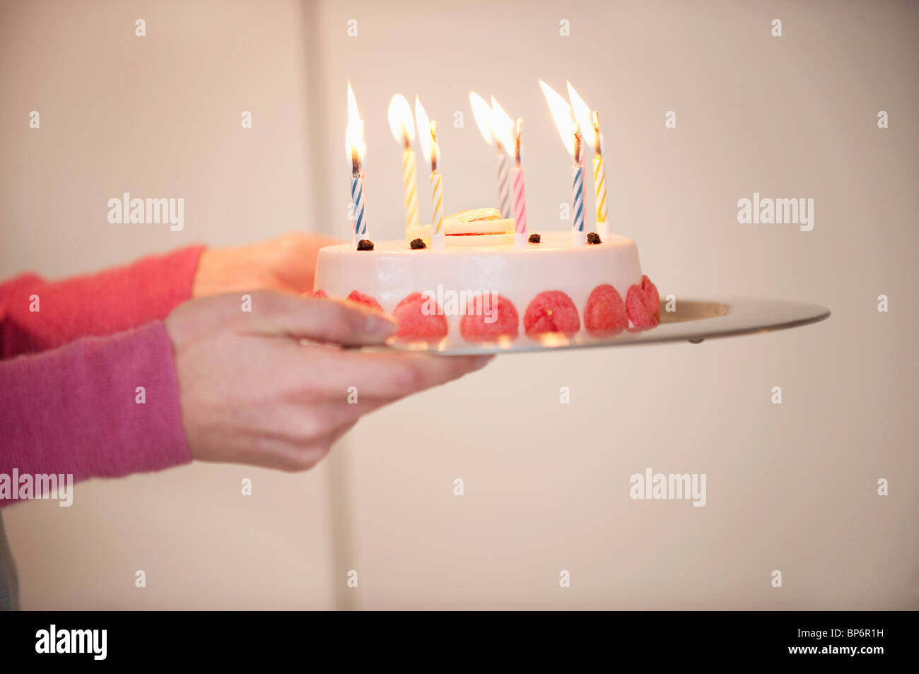 Close-up of a woman's hands holding a birthday cake Stock Photo - Alamy