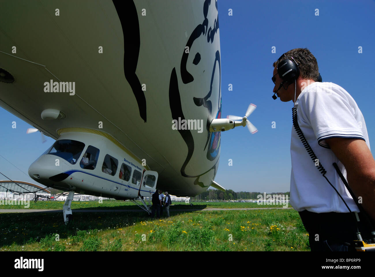 Member of ground crew supervising boarding of airship dirigible ...