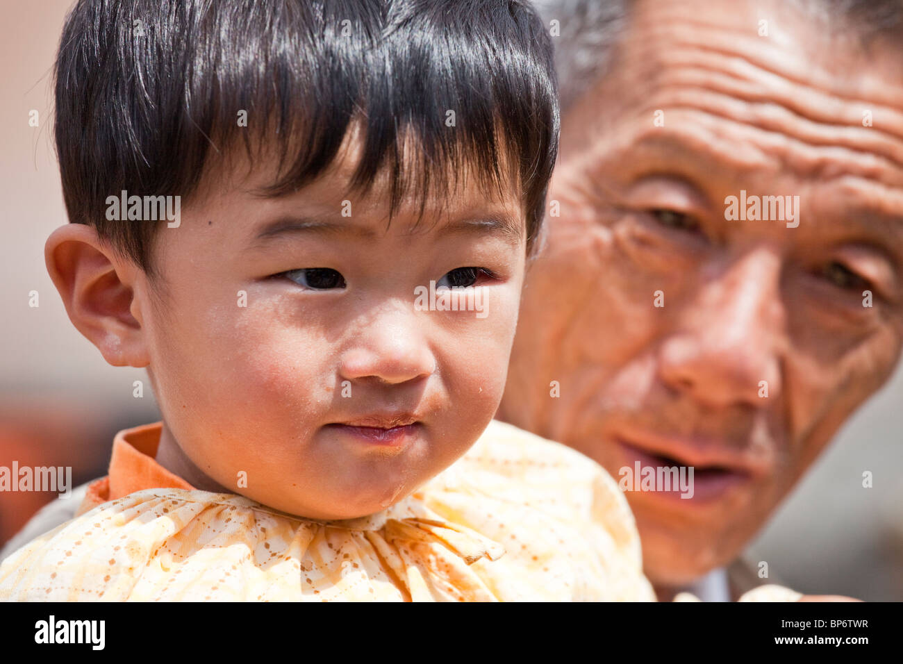 Little boy and his grandfather in Dali, China Stock Photo - Alamy