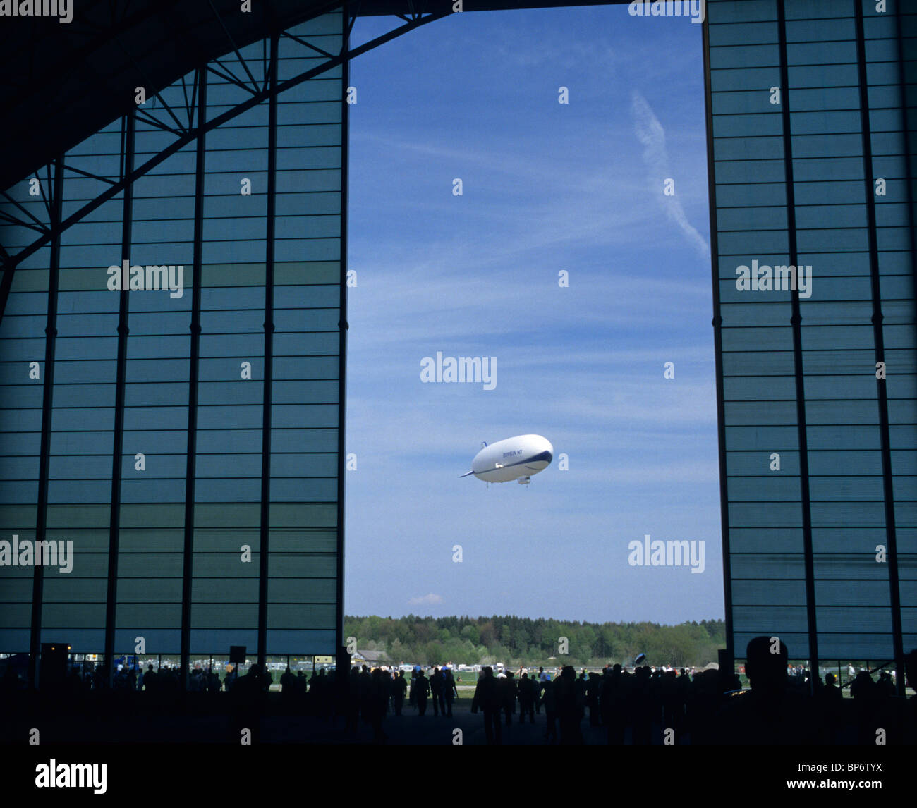 Viewed from his hangar doors, the modern airship dirigible Zeppelin NT ...