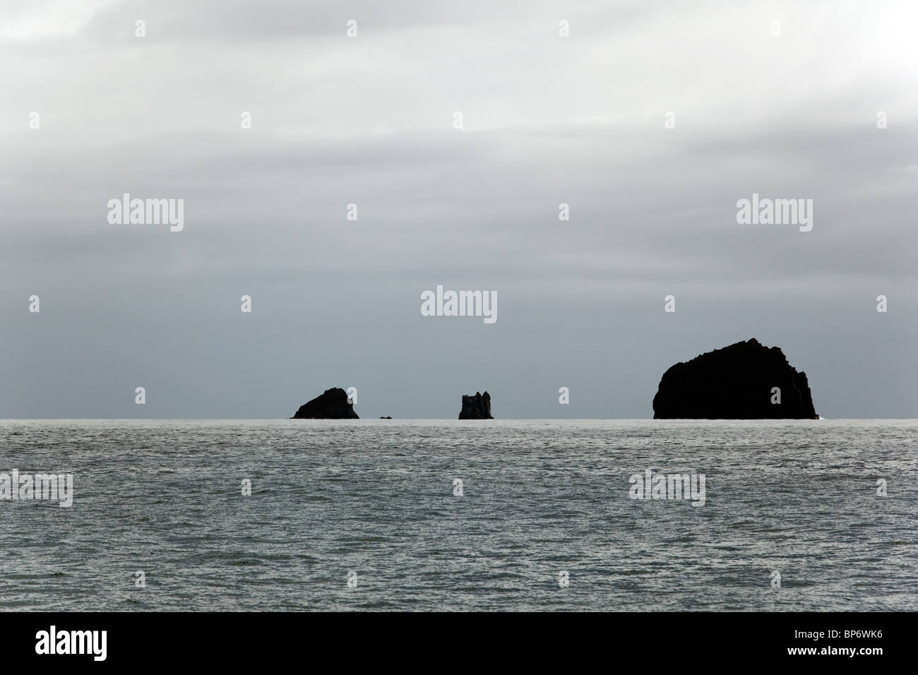 Jagged rocks raising out of the ocean Stock Photo - Alamy