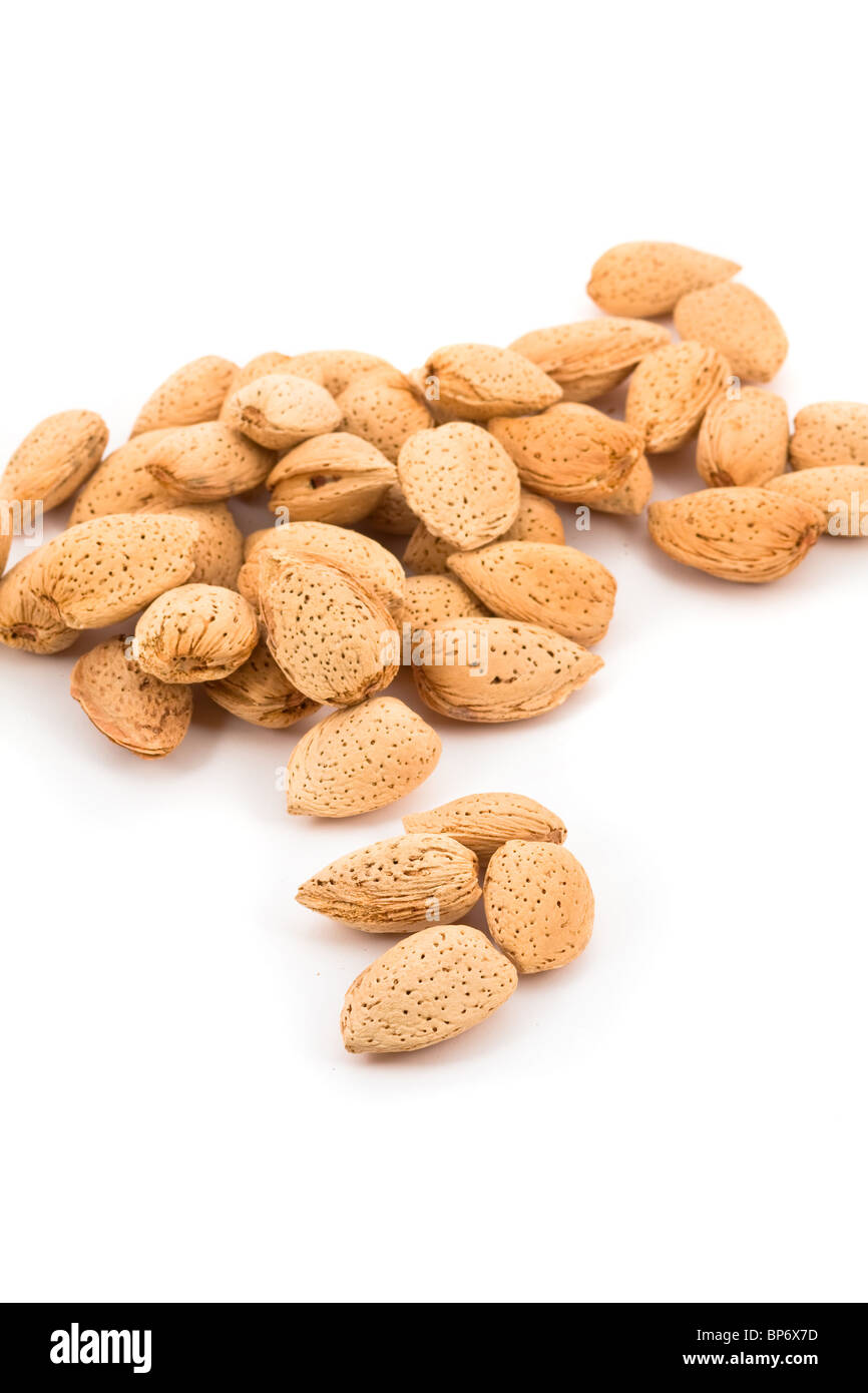 Pile of brown almonds over white background Stock Photo - Alamy
