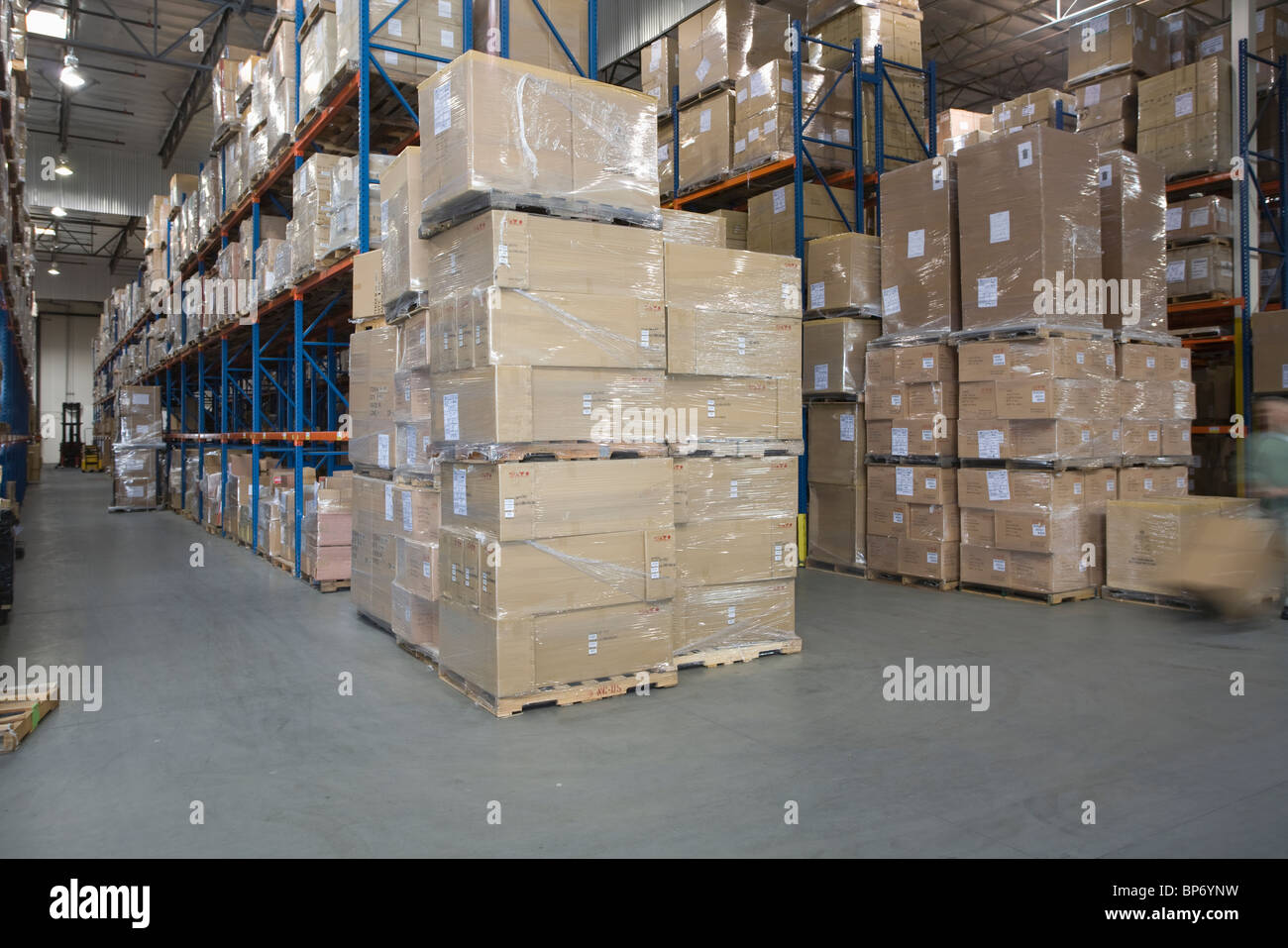 Cardboard boxes stacked in distribution warehouse Stock Photo - Alamy