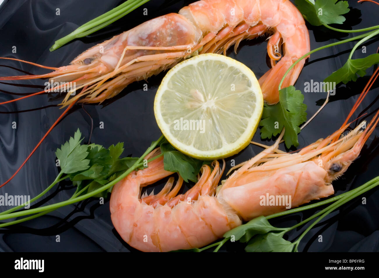 two prawn in a black dish Stock Photo - Alamy
