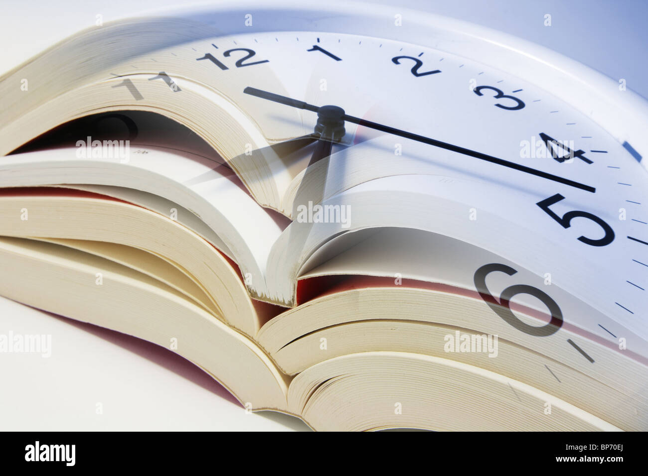 Clock and Stack of Books Stock Photo - Alamy