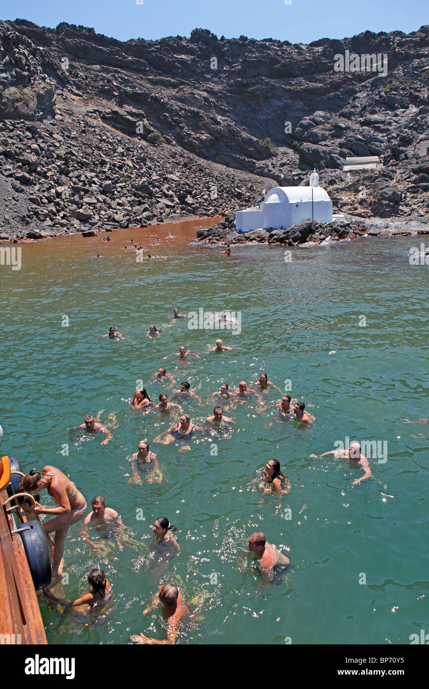swimming in the hot springs of Palea Kameni Island, Santorini, Cyclades ...