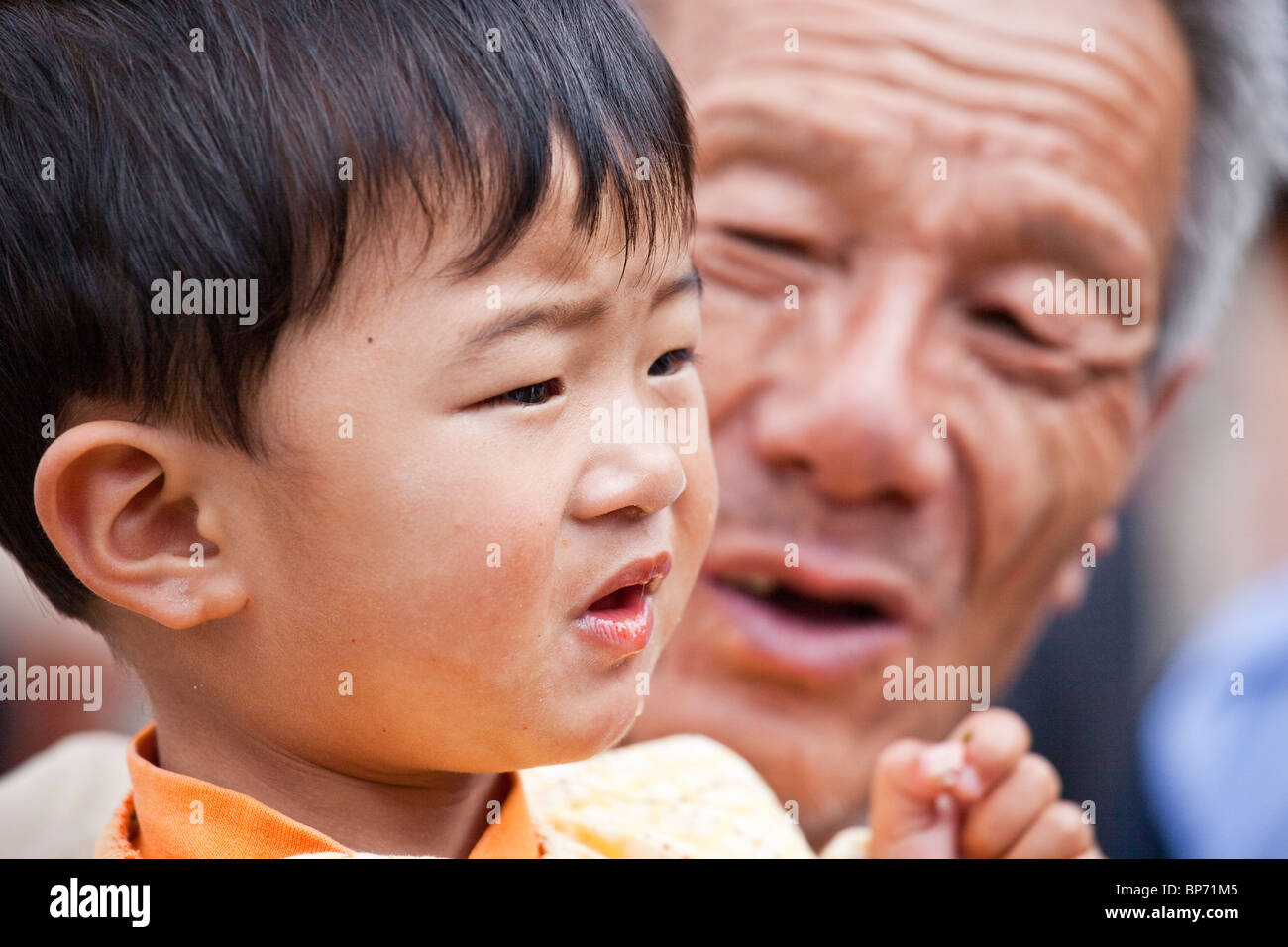 Little boy and his grandfather in Dali, China Stock Photo - Alamy