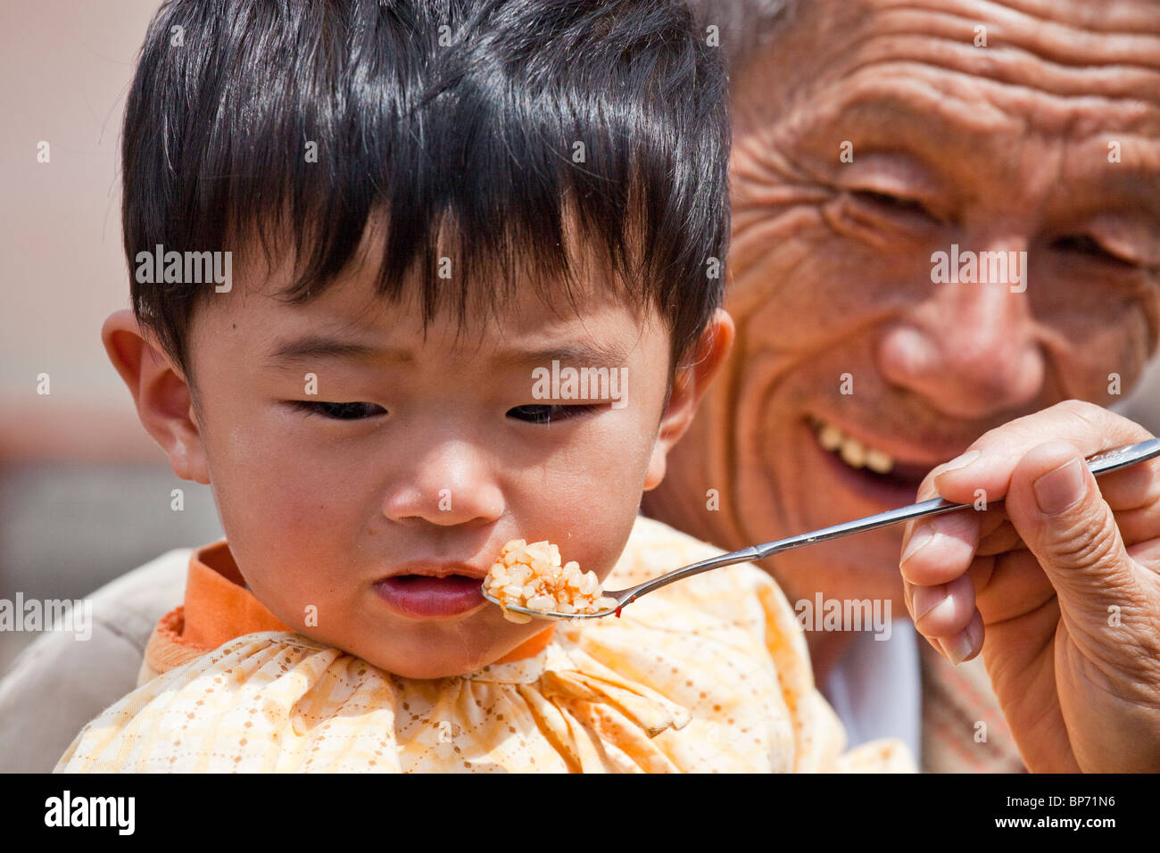 Little boy and his grandfather in Dali, China Stock Photo - Alamy