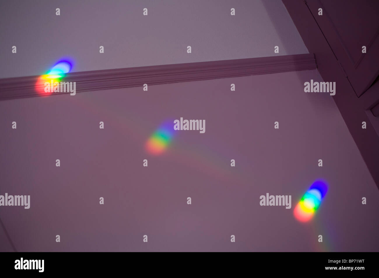 A colour (color) spectrum of visible light shines onto bedroom wall ...