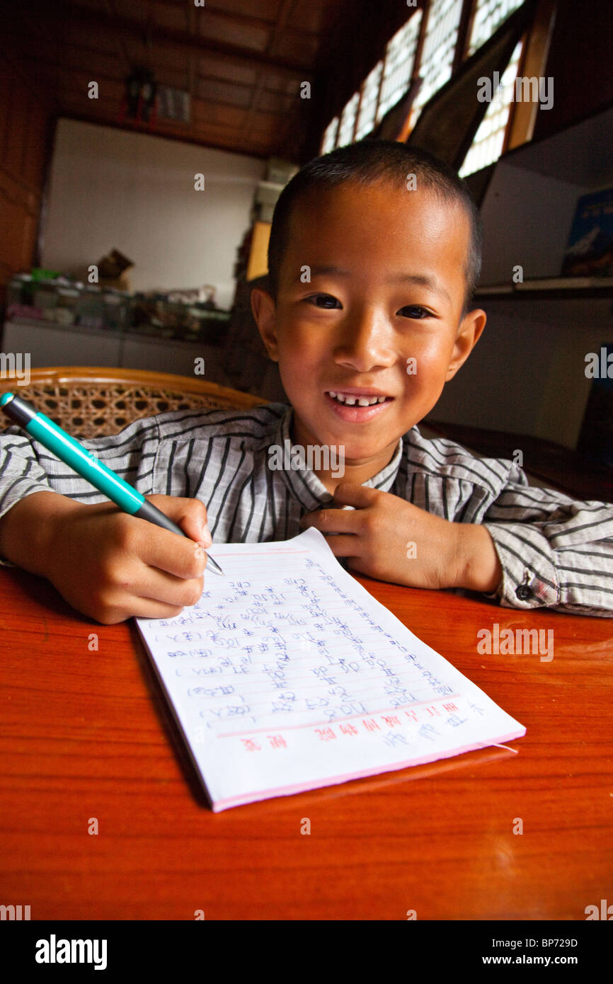 Chinese boy writing in Chinese, Lijiang, Yunnan Province, China Stock ...