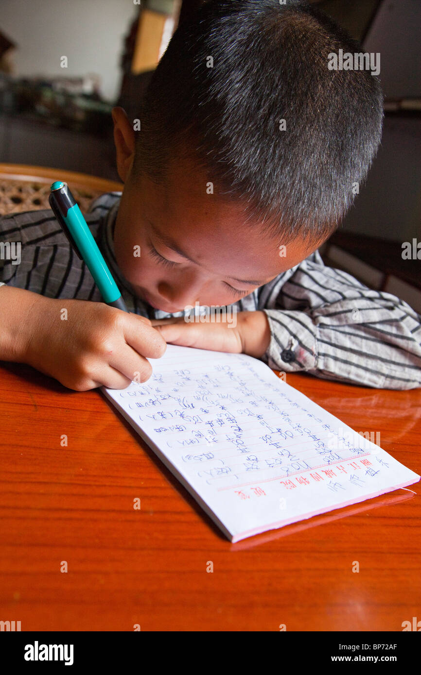 Chinese boy writing in Chinese, Lijiang, Yunnan Province, China Stock ...