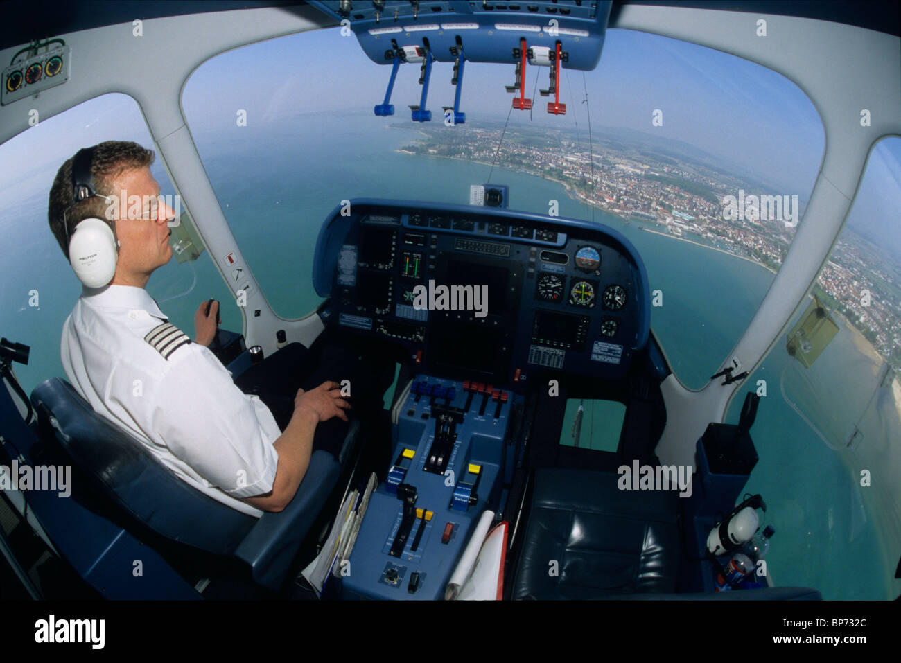 Pilot in cockpit flying the airship dirigible Zeppelin NT over ...