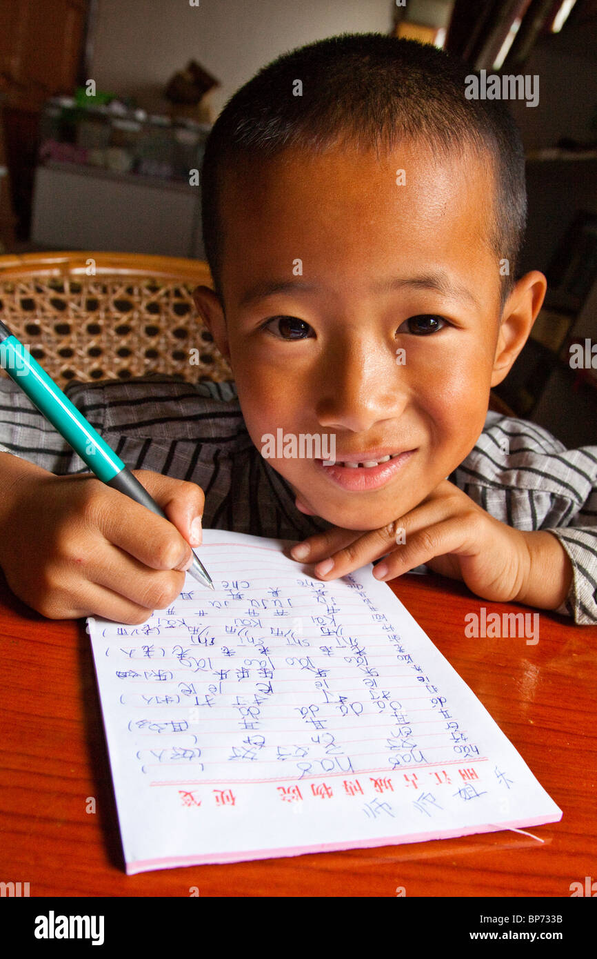 Chinese boy writing in Chinese, Lijiang, Yunnan Province, China Stock ...