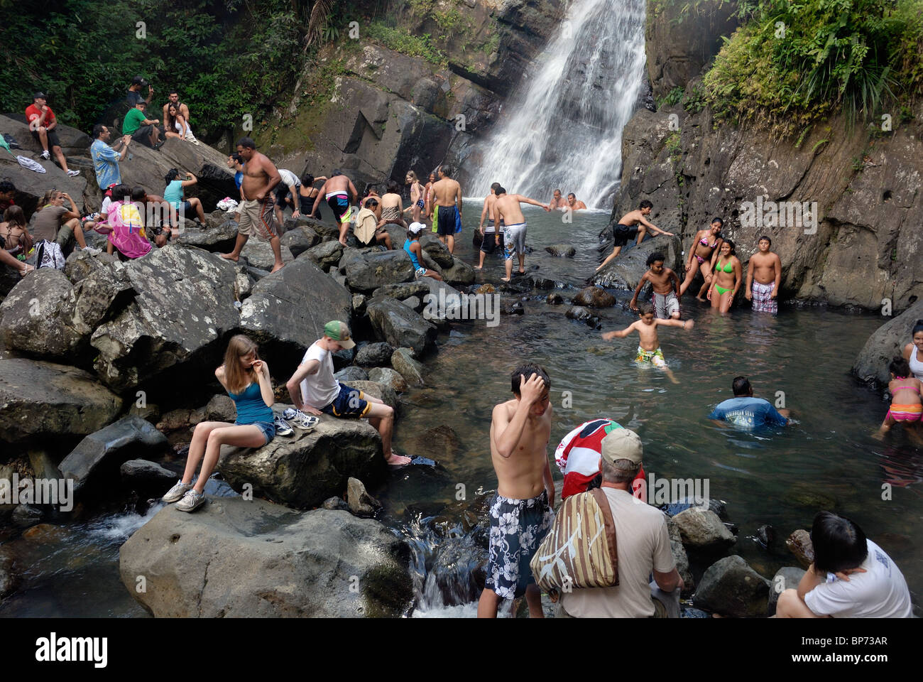 locals and tourists mingle at La Mina waterfall, El Yunque, rain forest ...