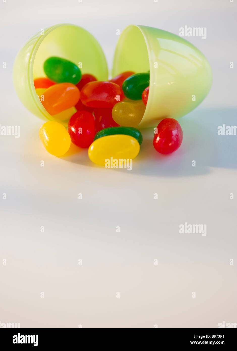 Jelly beans in a plastic Easter egg Stock Photo - Alamy