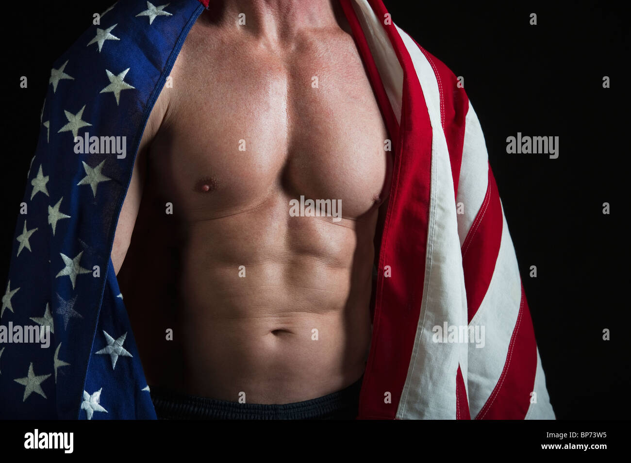 Muscular man wearing American flag as a cape Stock Photo - Alamy