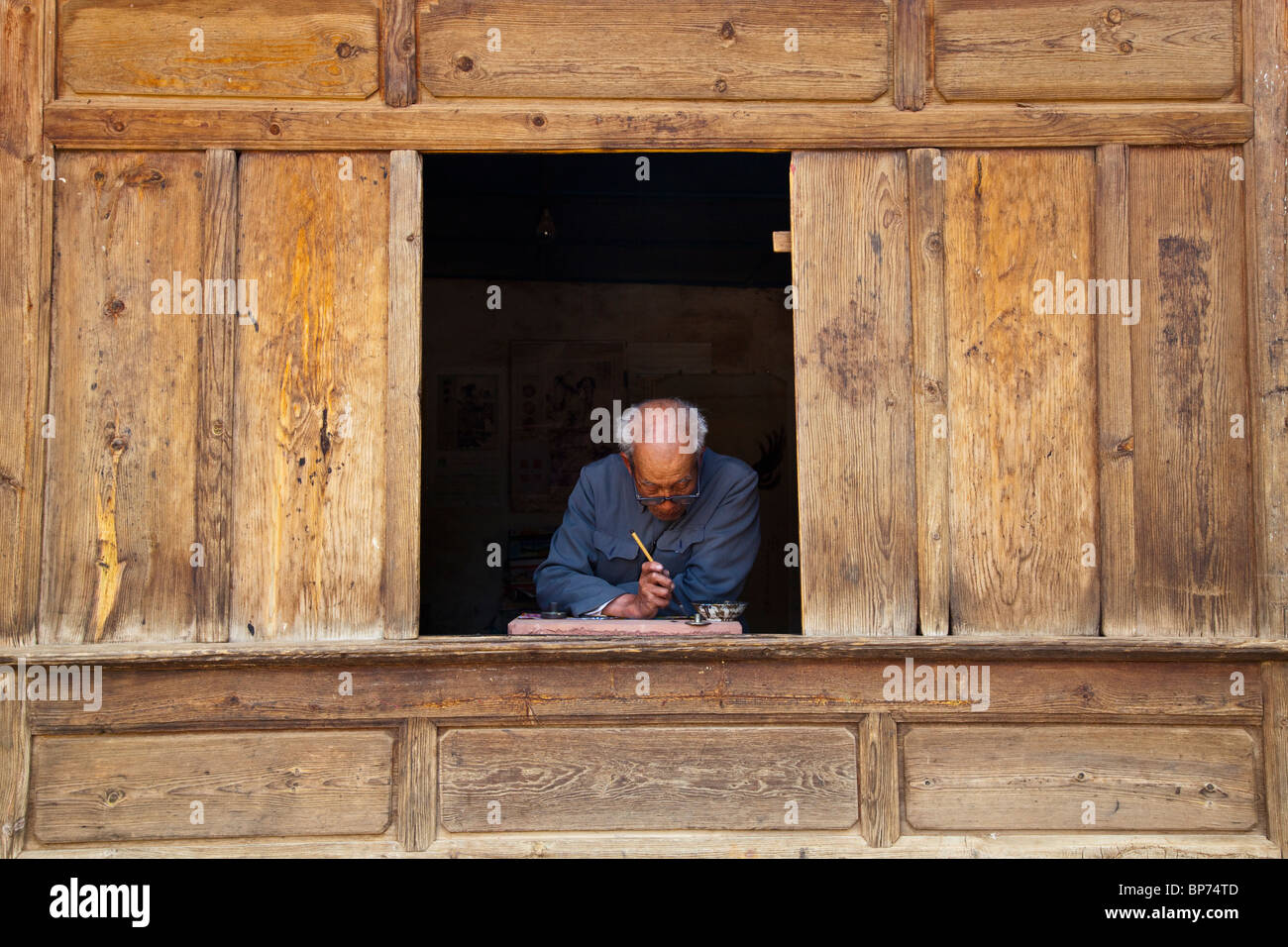 Old man writing in Shaxi Village, Yunnan Province, China Stock Photo ...