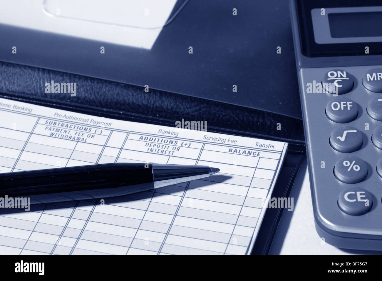 Checkbook and pen close up Stock Photo - Alamy