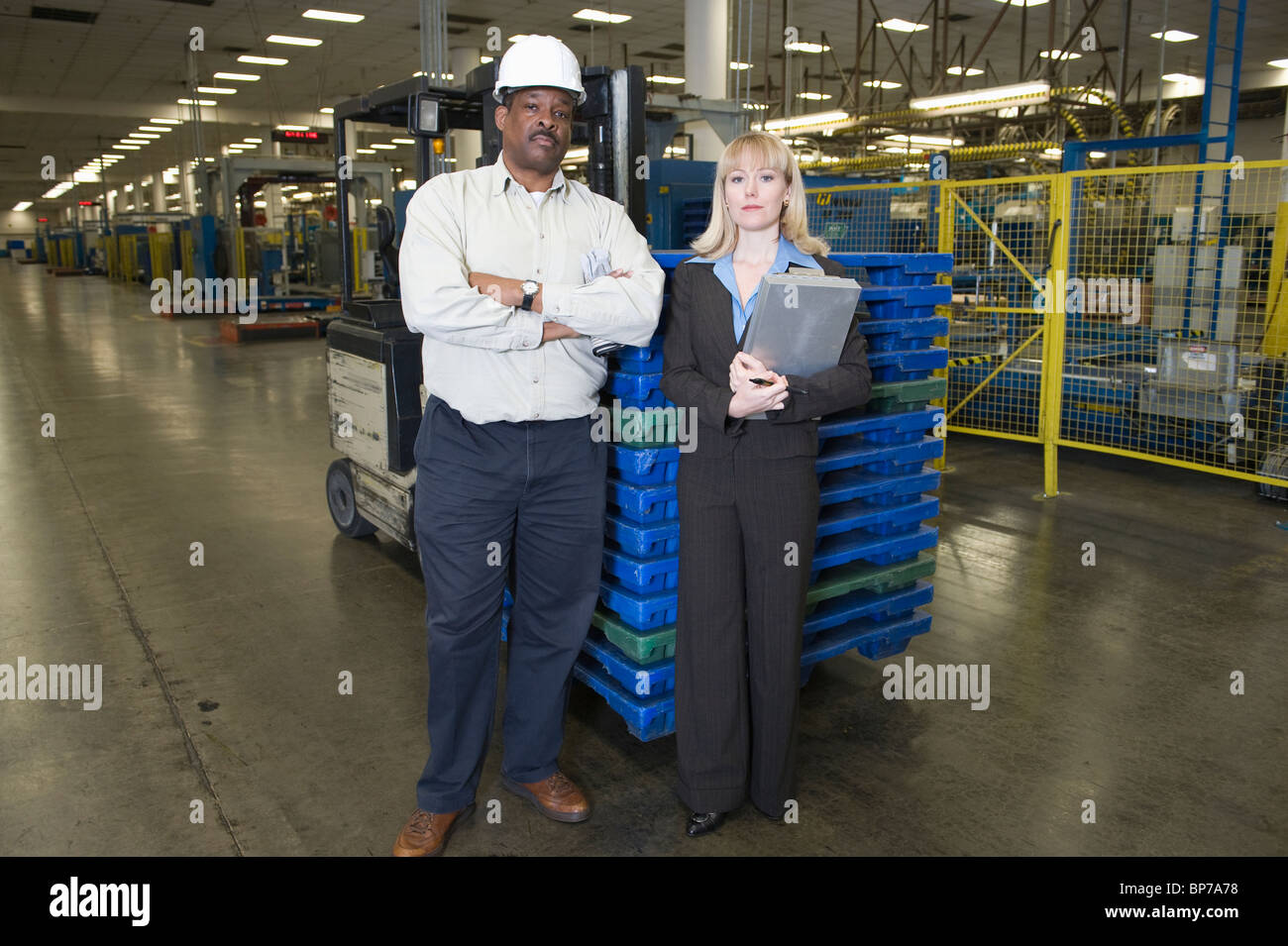 Man and woman working in newspaper factory Stock Photo - Alamy