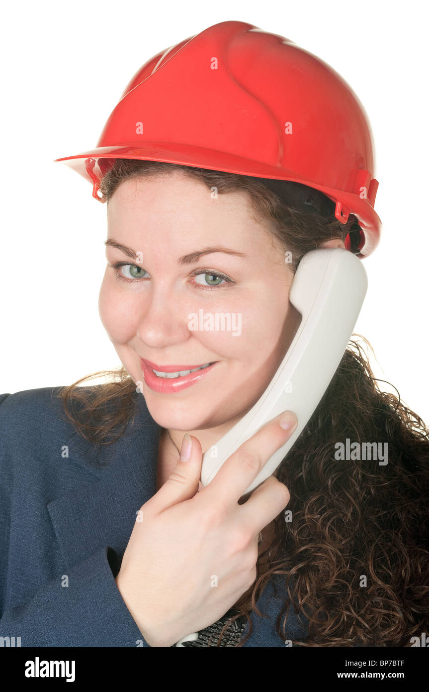 Young beautiful woman in red hard hat calling by phone. Isolated on ...