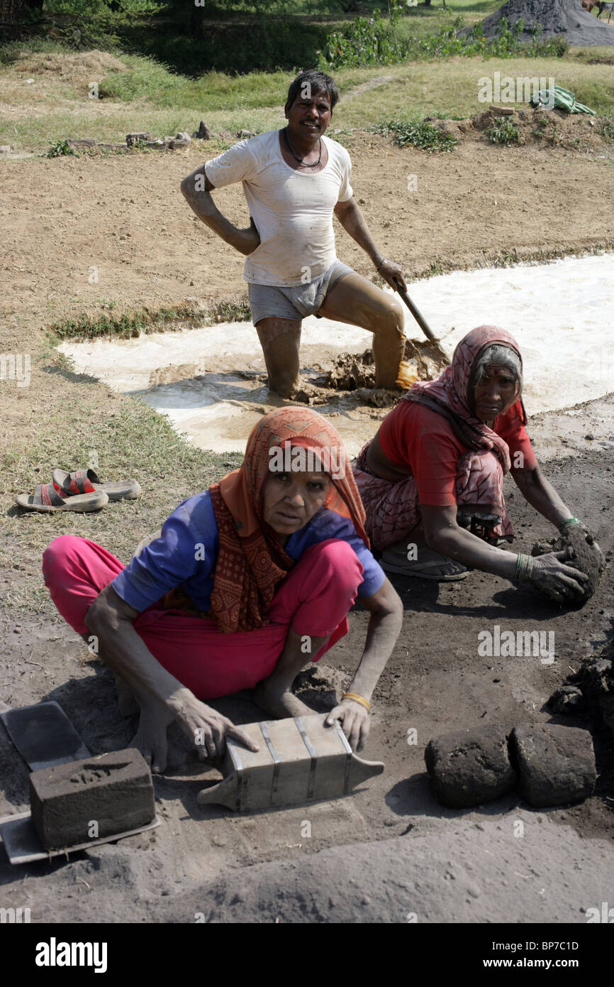 Women making bricks by hand in a factory on the outskirts of Ujjain ...