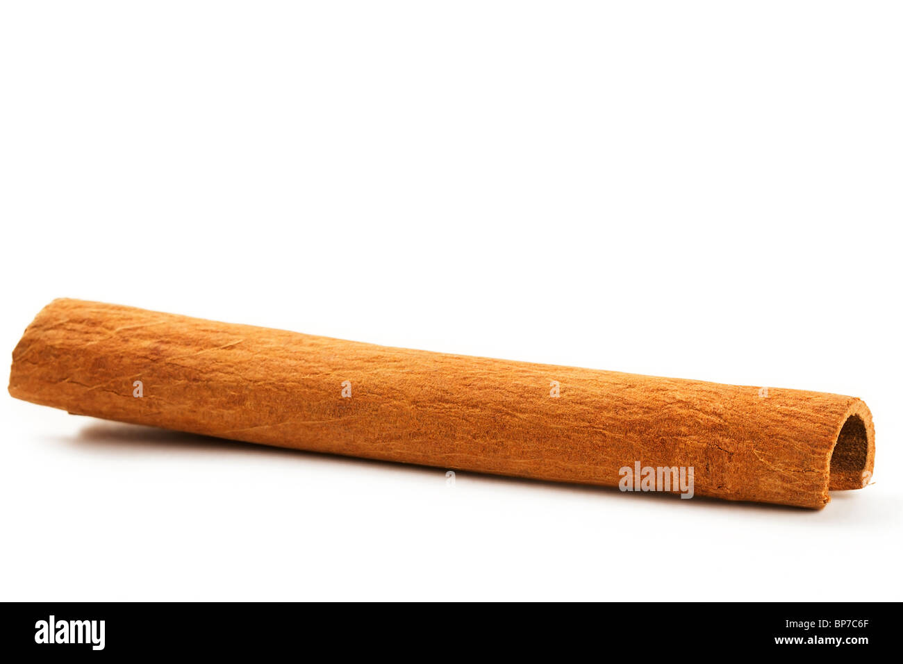 one cinnamon stick on white background Stock Photo - Alamy