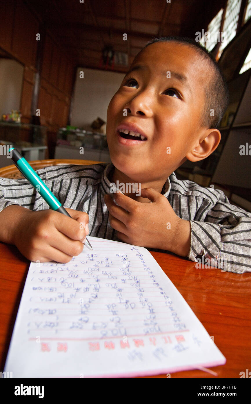 Chinese boy writing in Chinese, Lijiang, Yunnan Province, China Stock ...