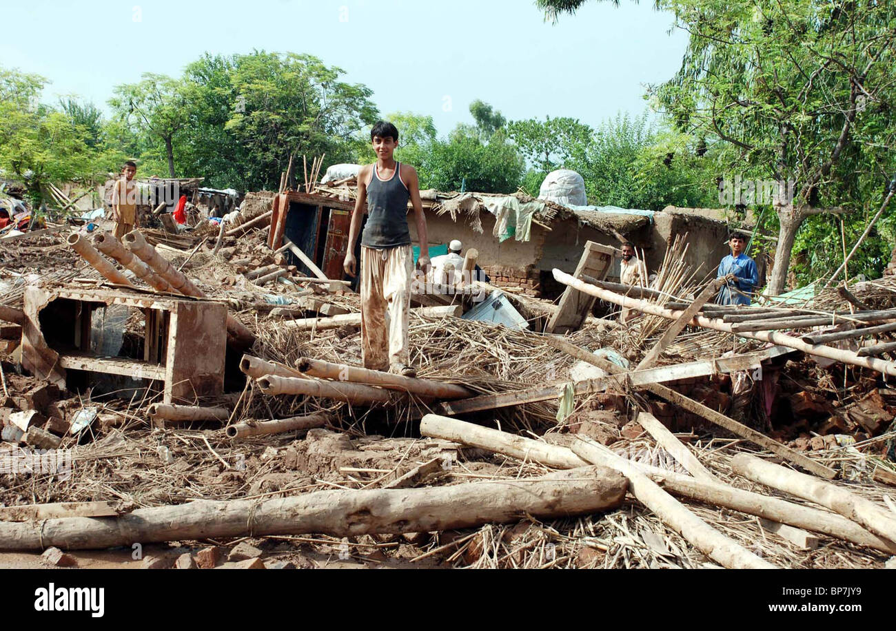 People removing household items from their collapsed house after the ...