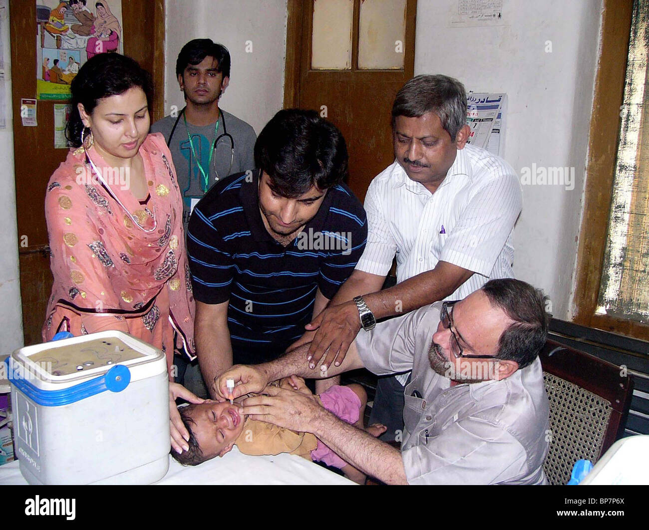 Doctor gives treatment to a flood affected child at flood relief camp ...