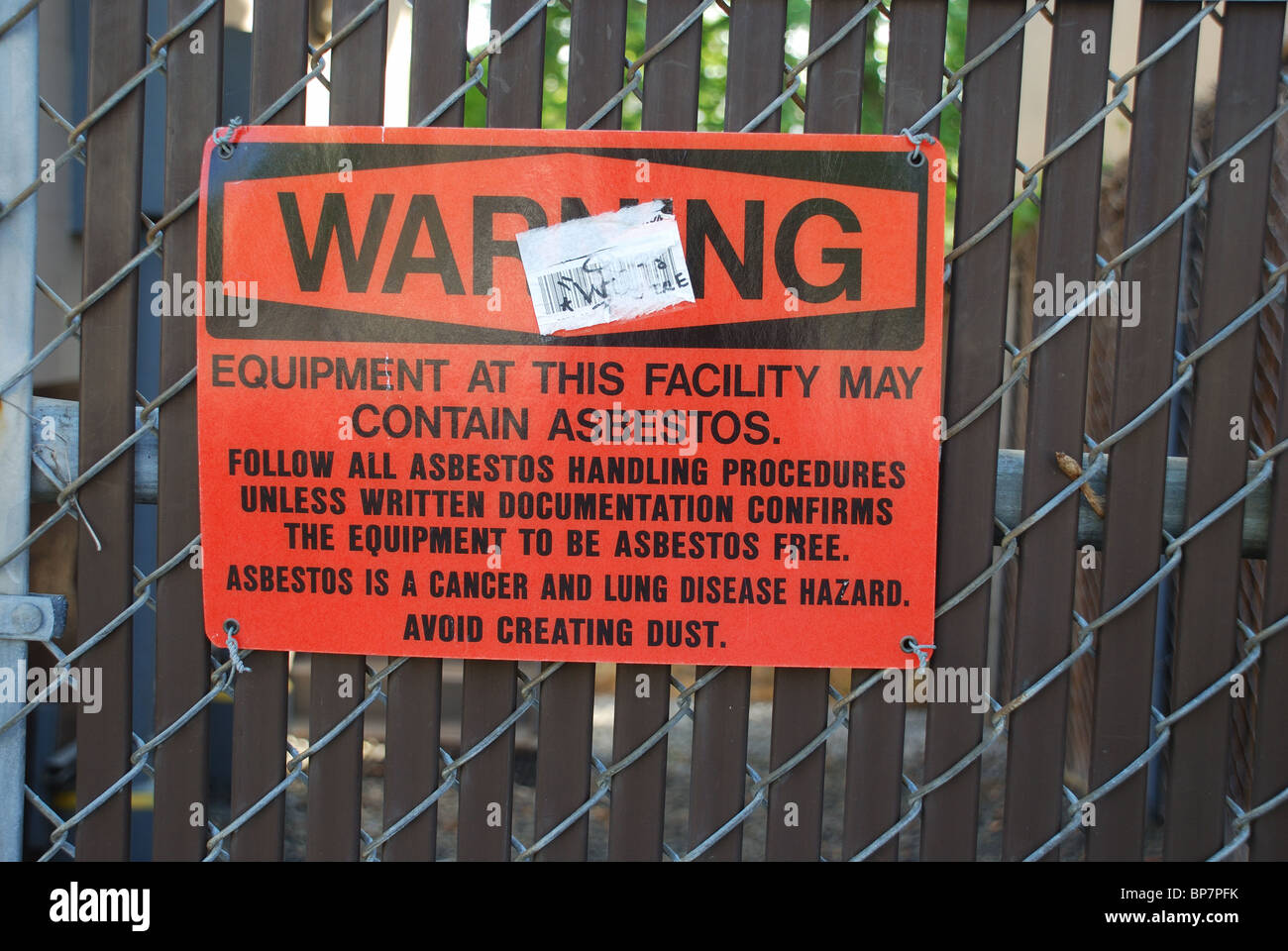 Orange sign warning of possible presence of asbestos Stock Photo - Alamy