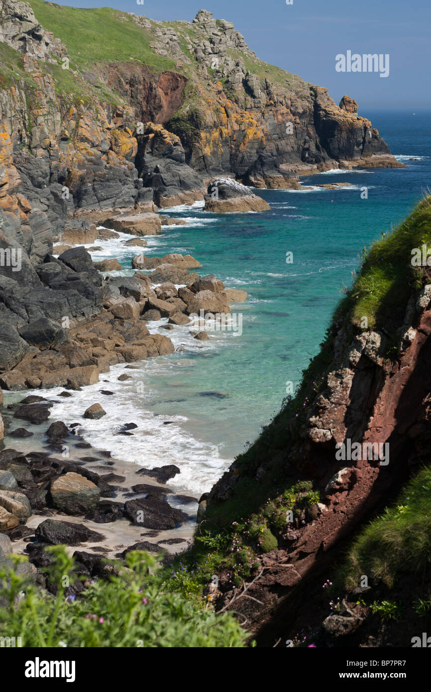 An Isolated and rocky tidal beach . High cliffs surround a small sandy ...