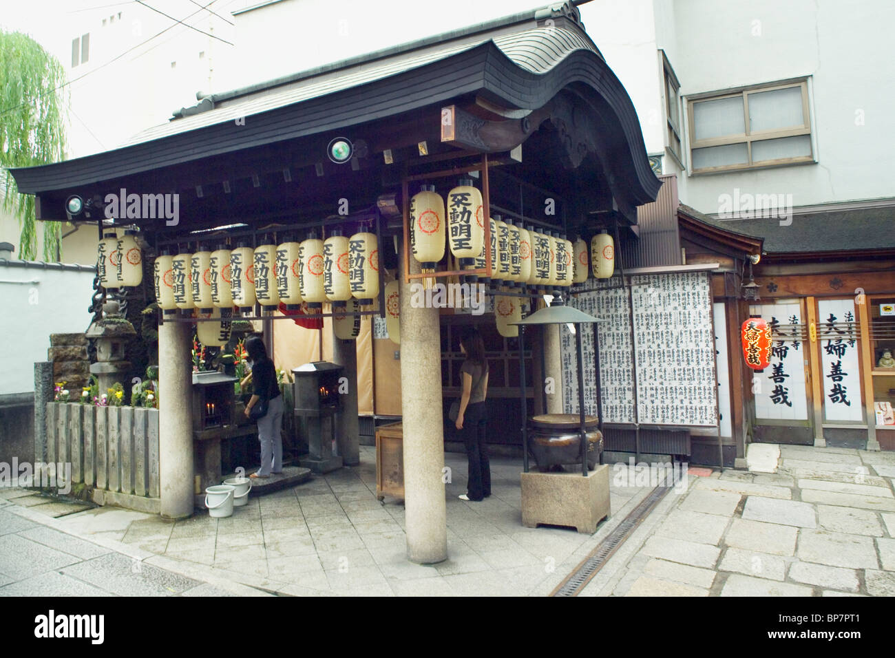 Women Praying at a Traditional Japanese Shrine. Osaka Prefecture, Japan ...